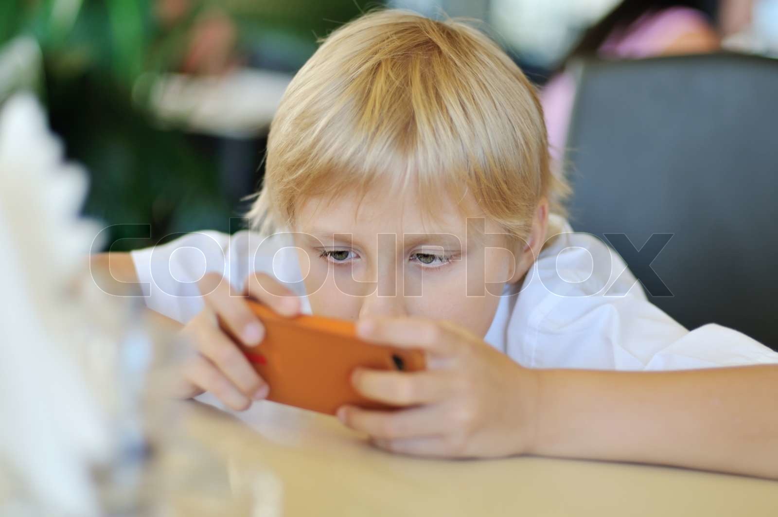 boy playing phone | Stock image | Colourbox