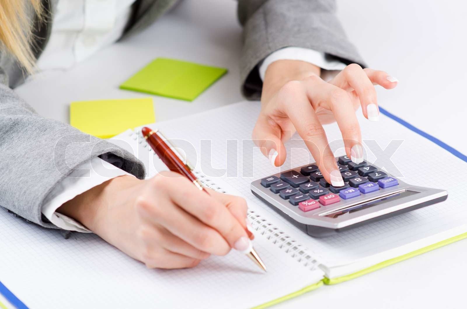 Hands working on the calculator | Stock image | Colourbox