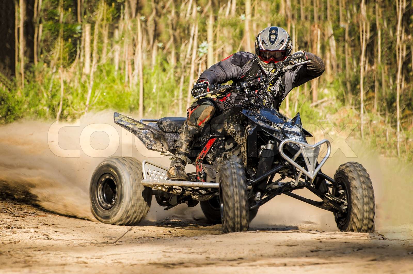 ATV racer takes a turn during a race | Stock image | Colourbox