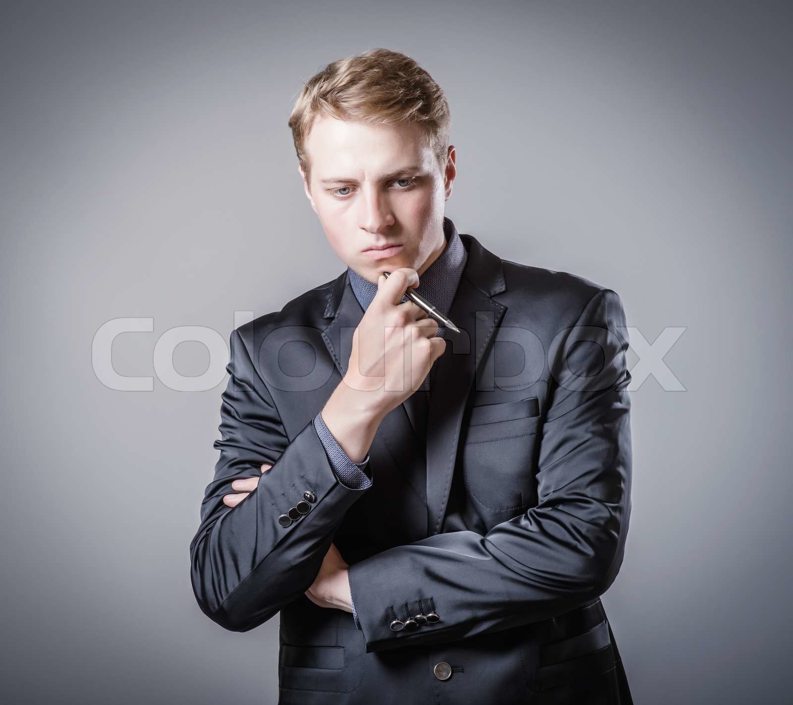 young man holding his hand under the chin | Stock image | Colourbox