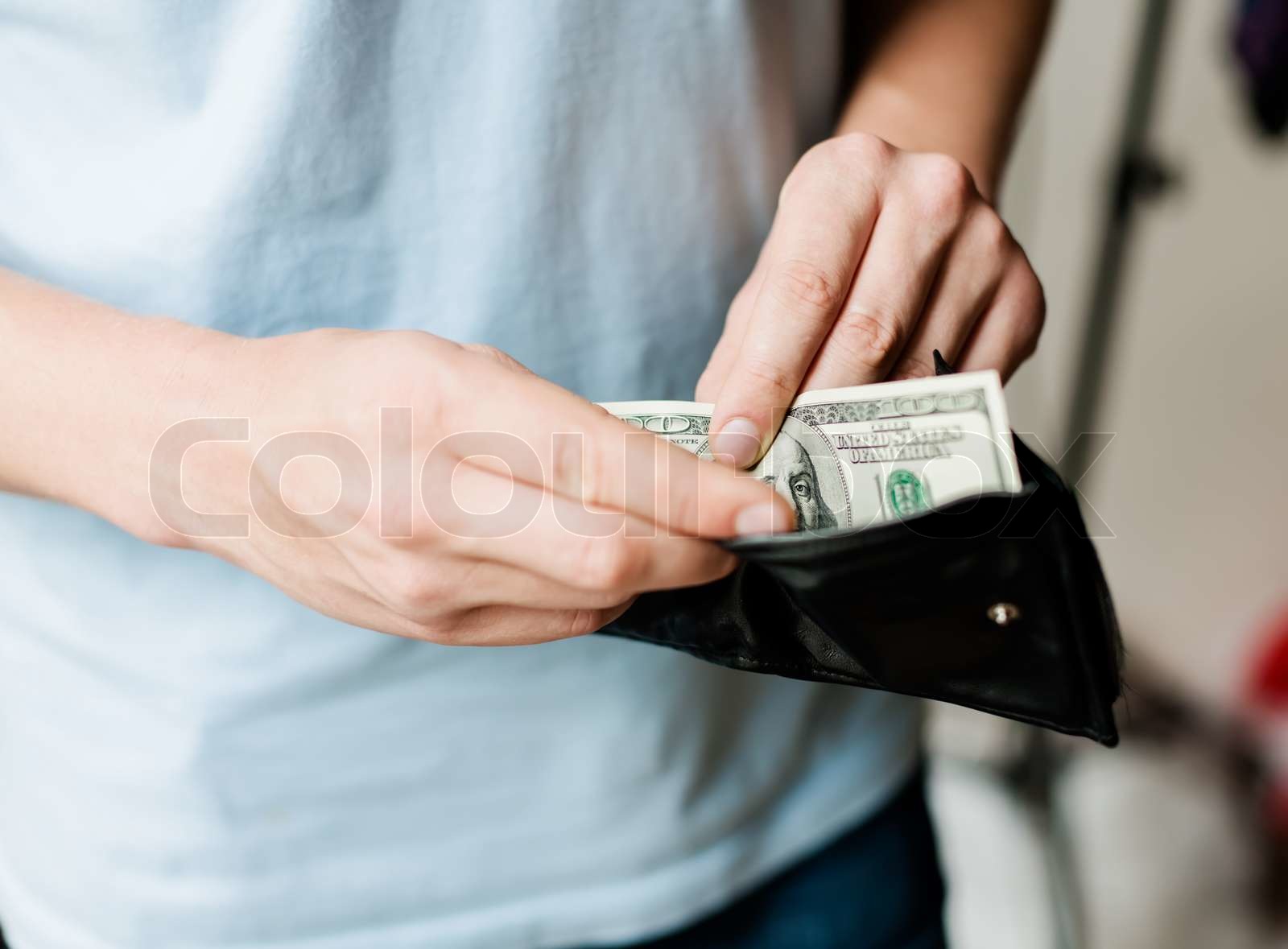 Man gets money from the wallet | Stock image | Colourbox