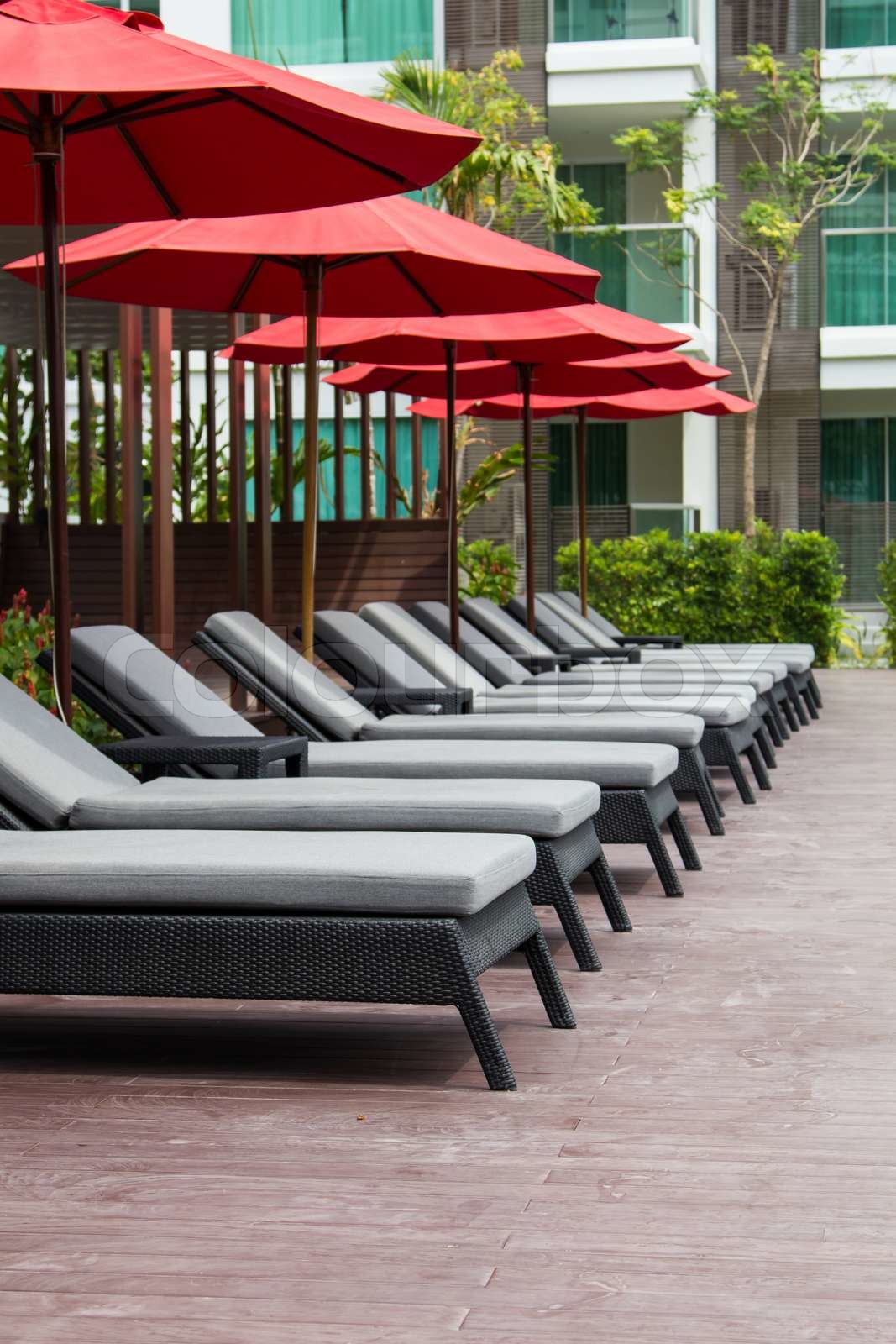 lounge chairs by the pool | Stock image | Colourbox