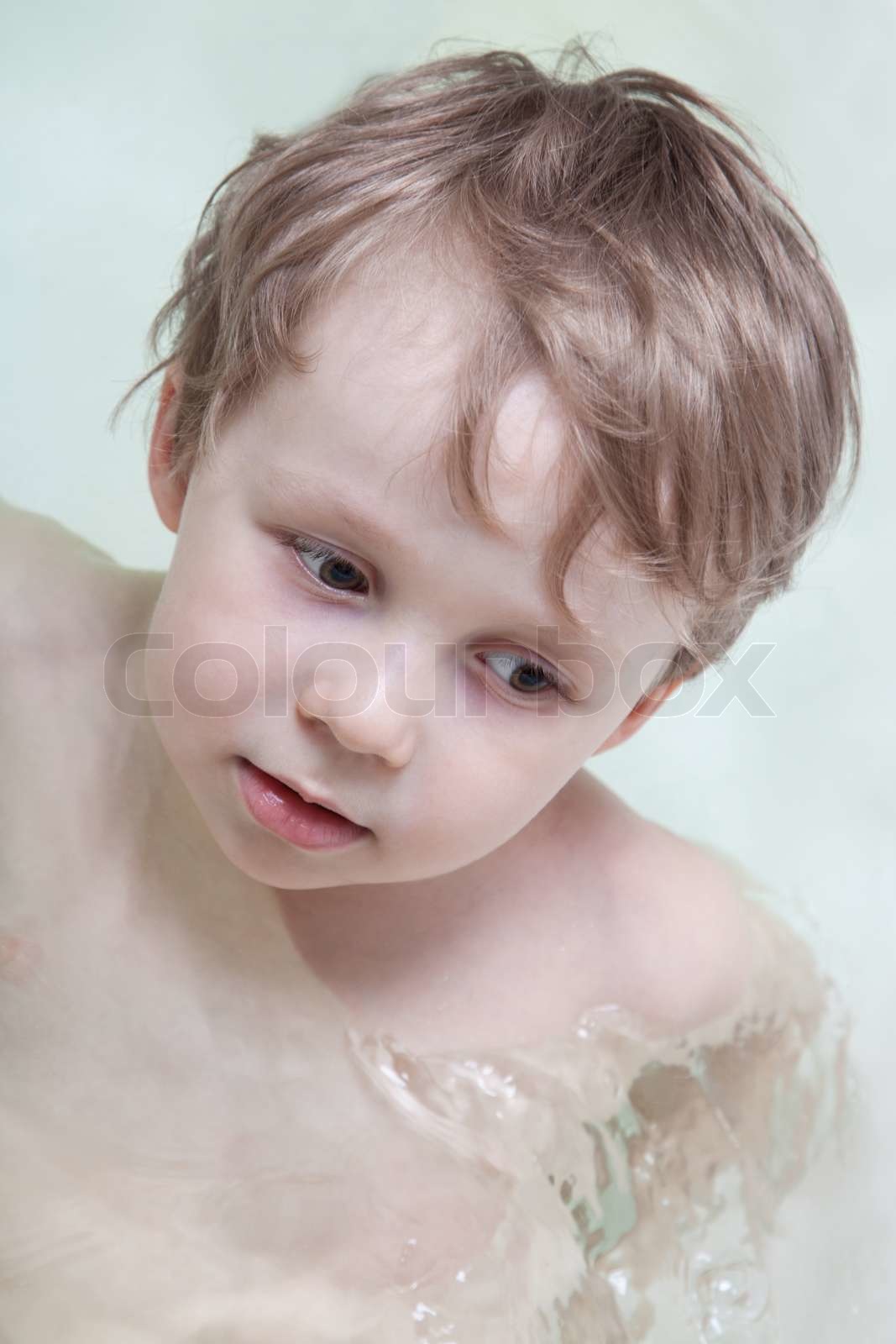 Boy bathing in bathtub | Stock image | Colourbox