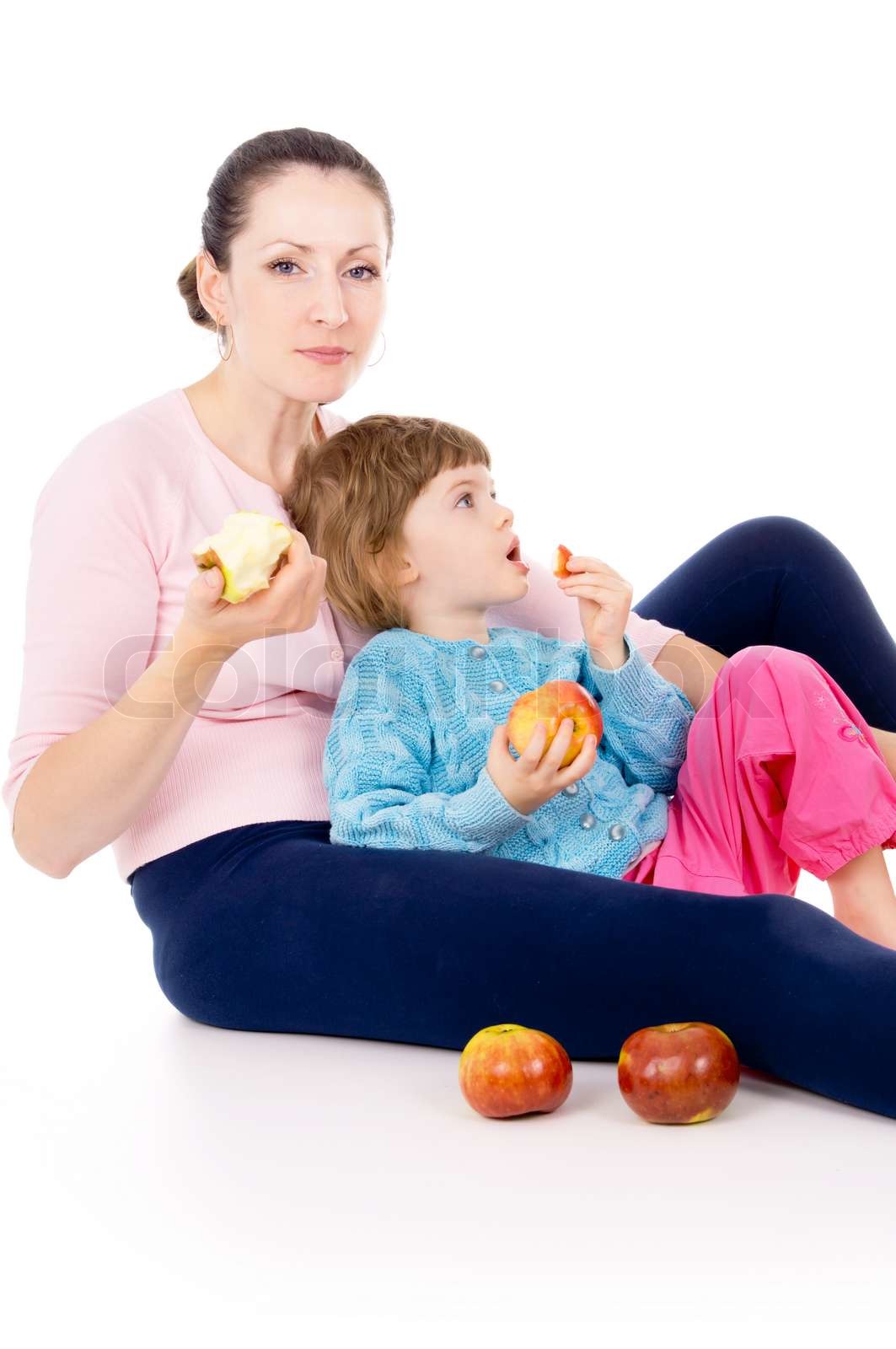 mother with a child eat apples | Stock image | Colourbox