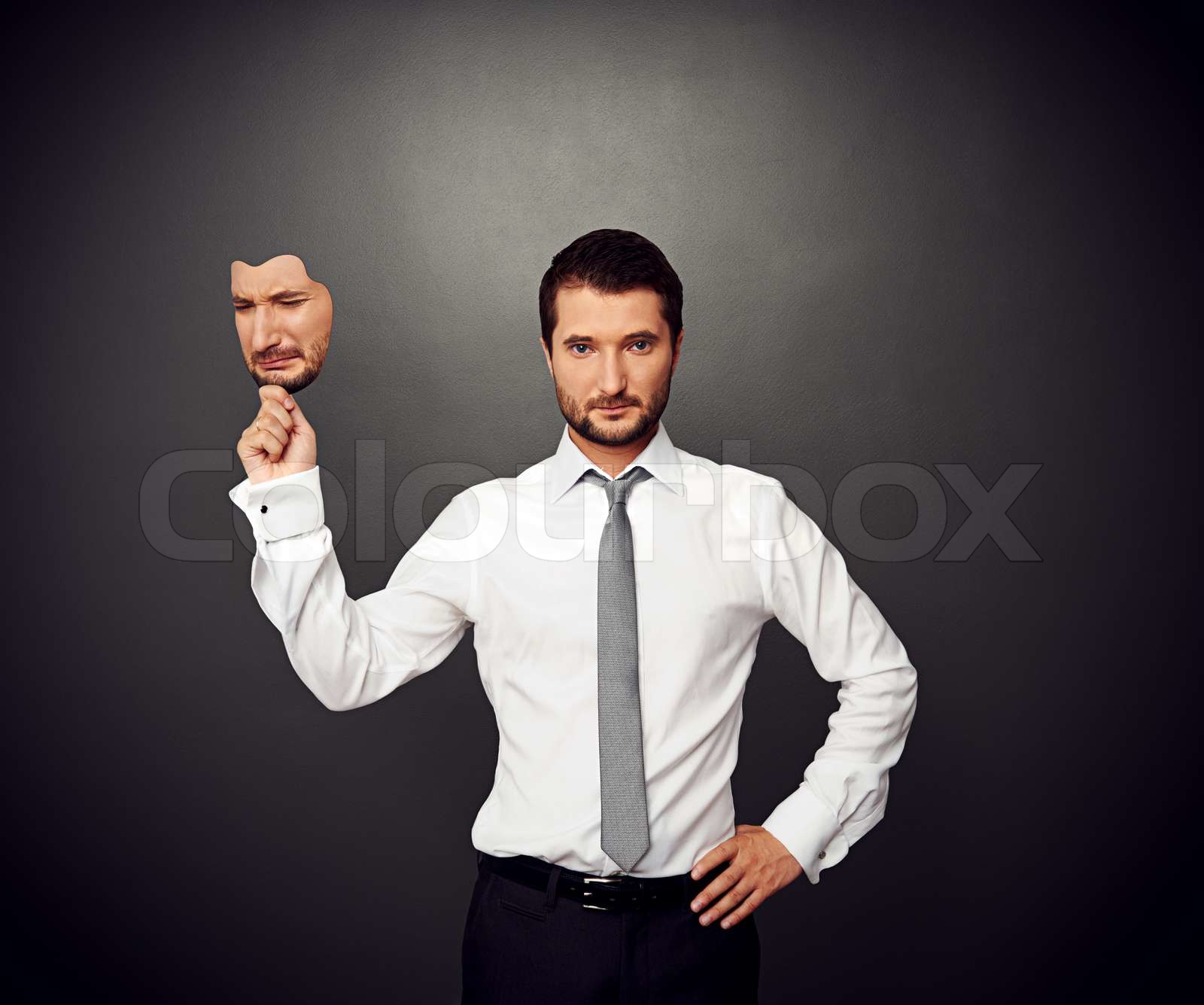 man holding mask with crying face | Stock image | Colourbox