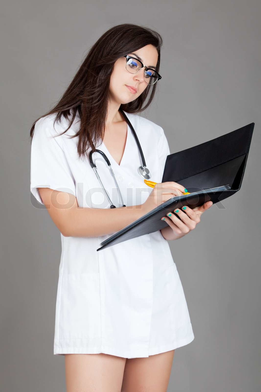 medical doctor woman with stethoscope A female doctor with a folder ...