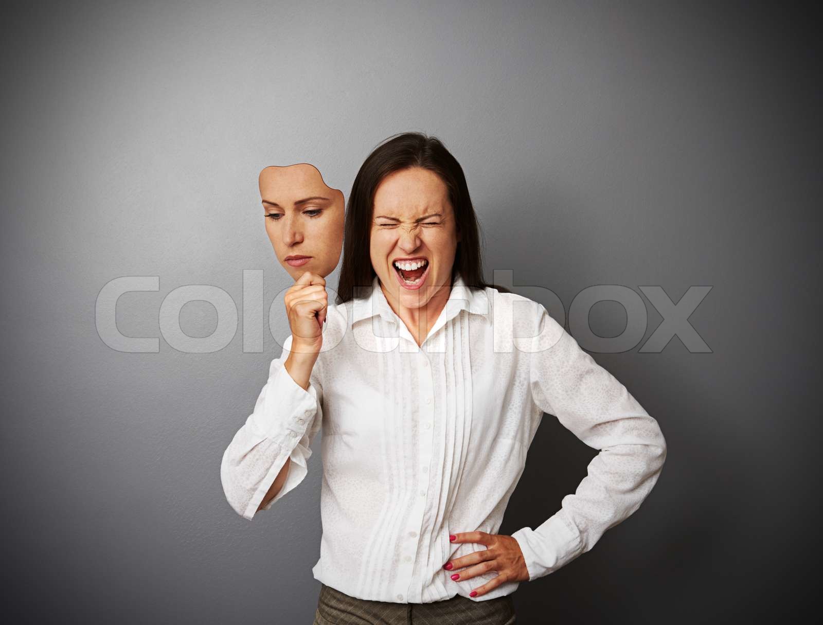 woman hiding her anger behind the mask | Stock image | Colourbox