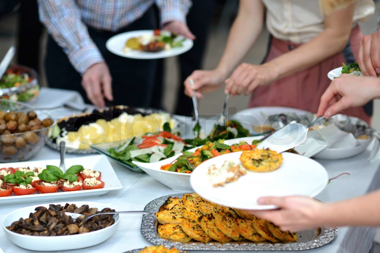 Picking up food from table with healthy colourful dishes | Stock image ...