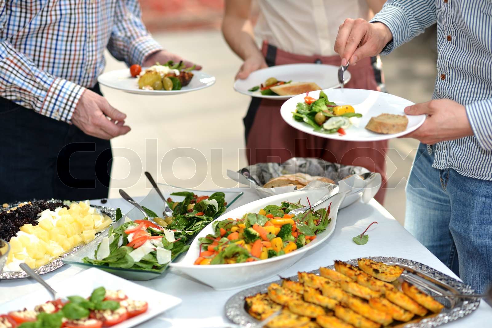 People picking up food from buffet | Stock image | Colourbox