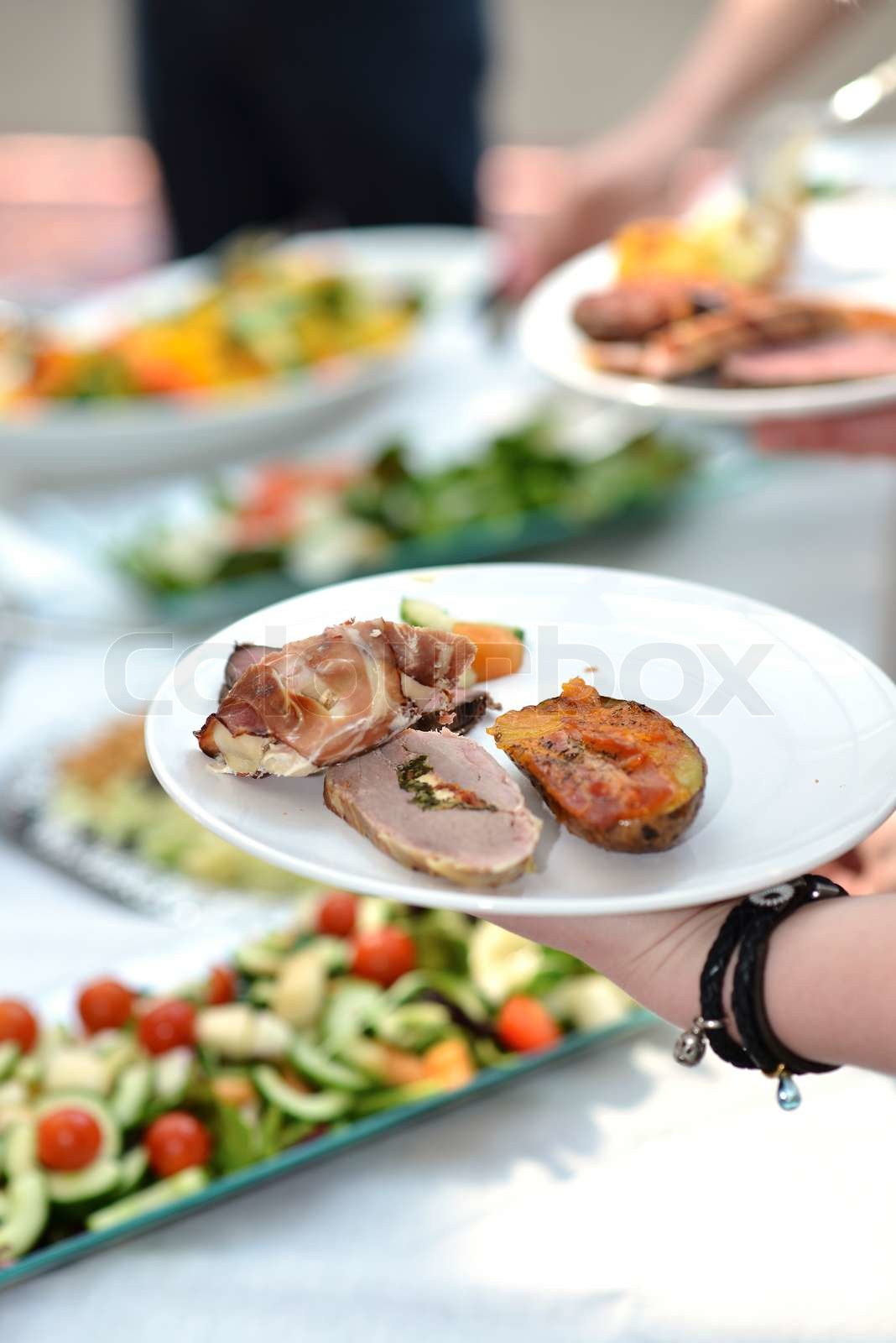 Picking up food at indoor buffet | Stock image | Colourbox
