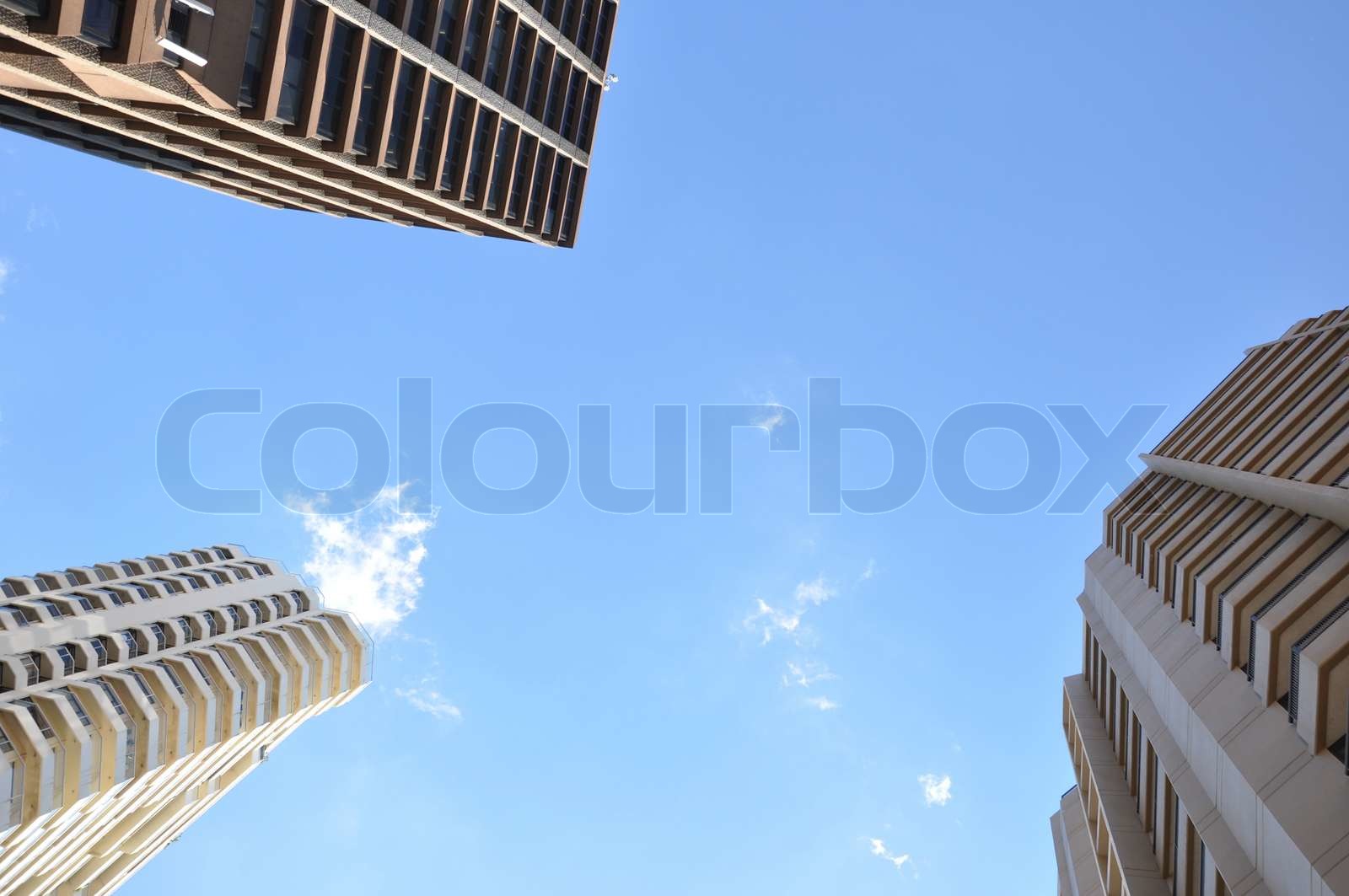 Buildings in blue sky background - looking up angle - Stock Image ...