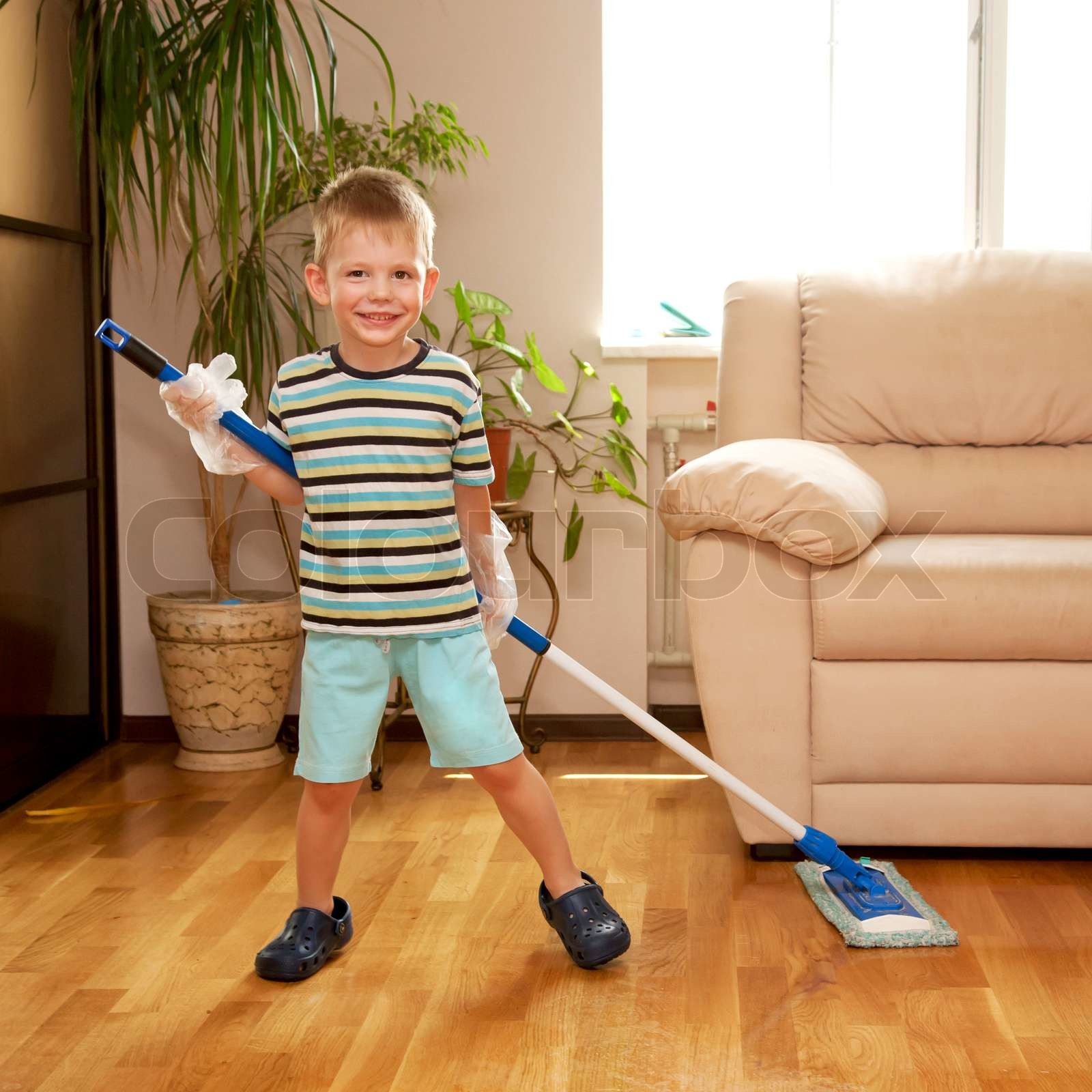 Little boy cleaning the apartment, washing the floor | Stock image ...
