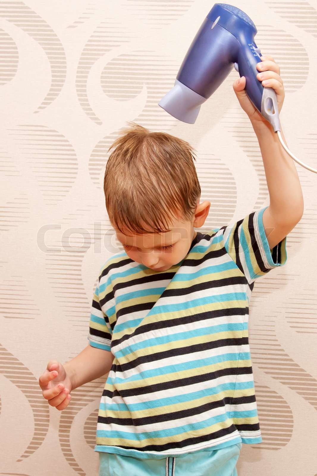little boy drying hair with hair dryer | Stock image | Colourbox