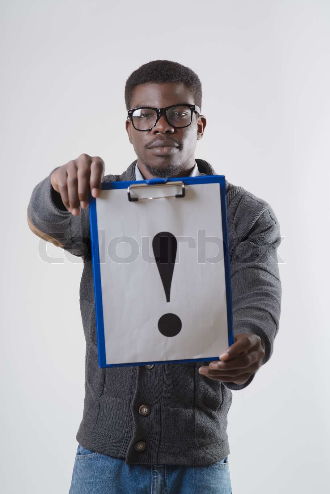 man holding a exclamation mark | Stock image | Colourbox