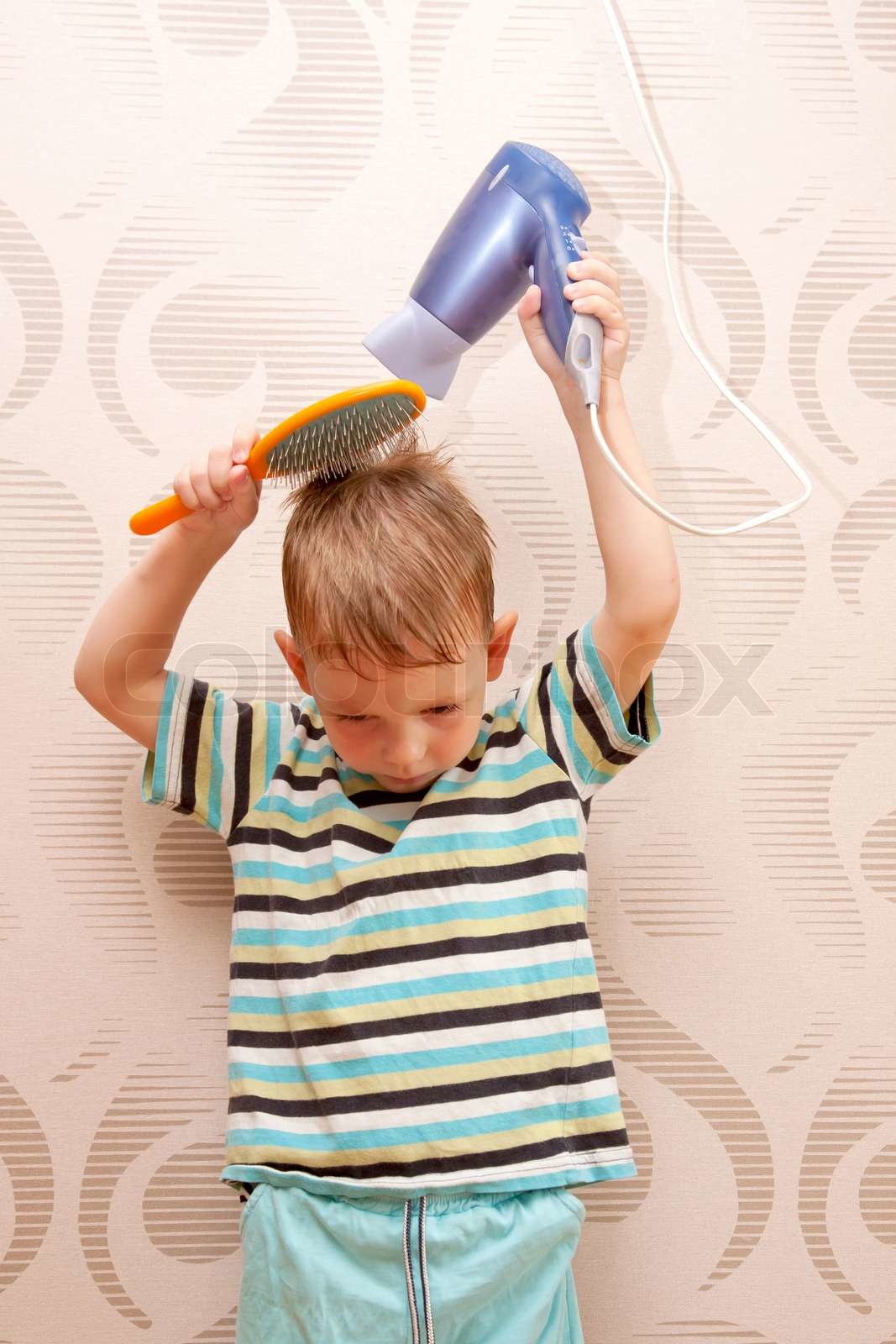 little boy drying hair with hair dryer | Stock image | Colourbox
