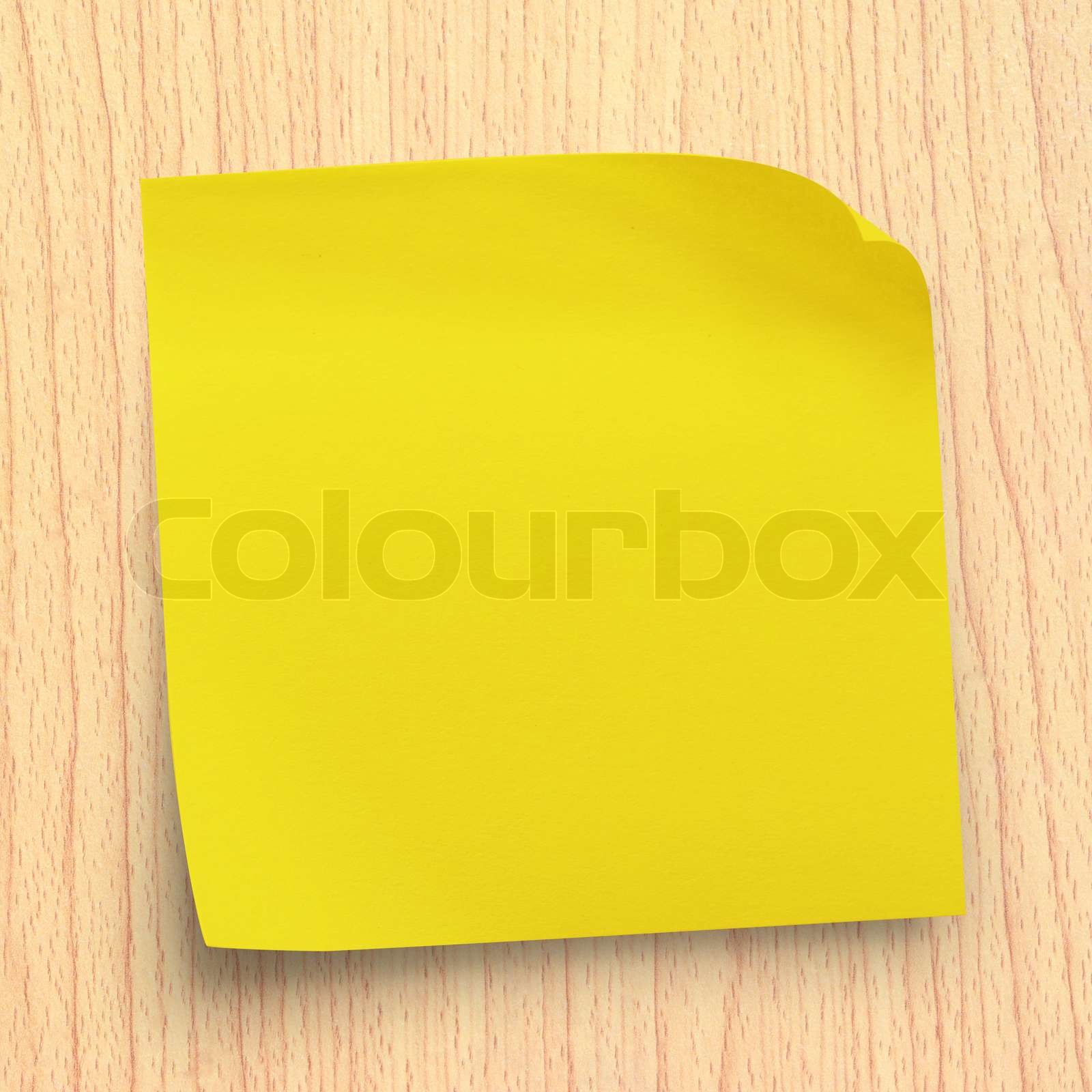 Yellow sticker note on plywood wall | Stock image | Colourbox