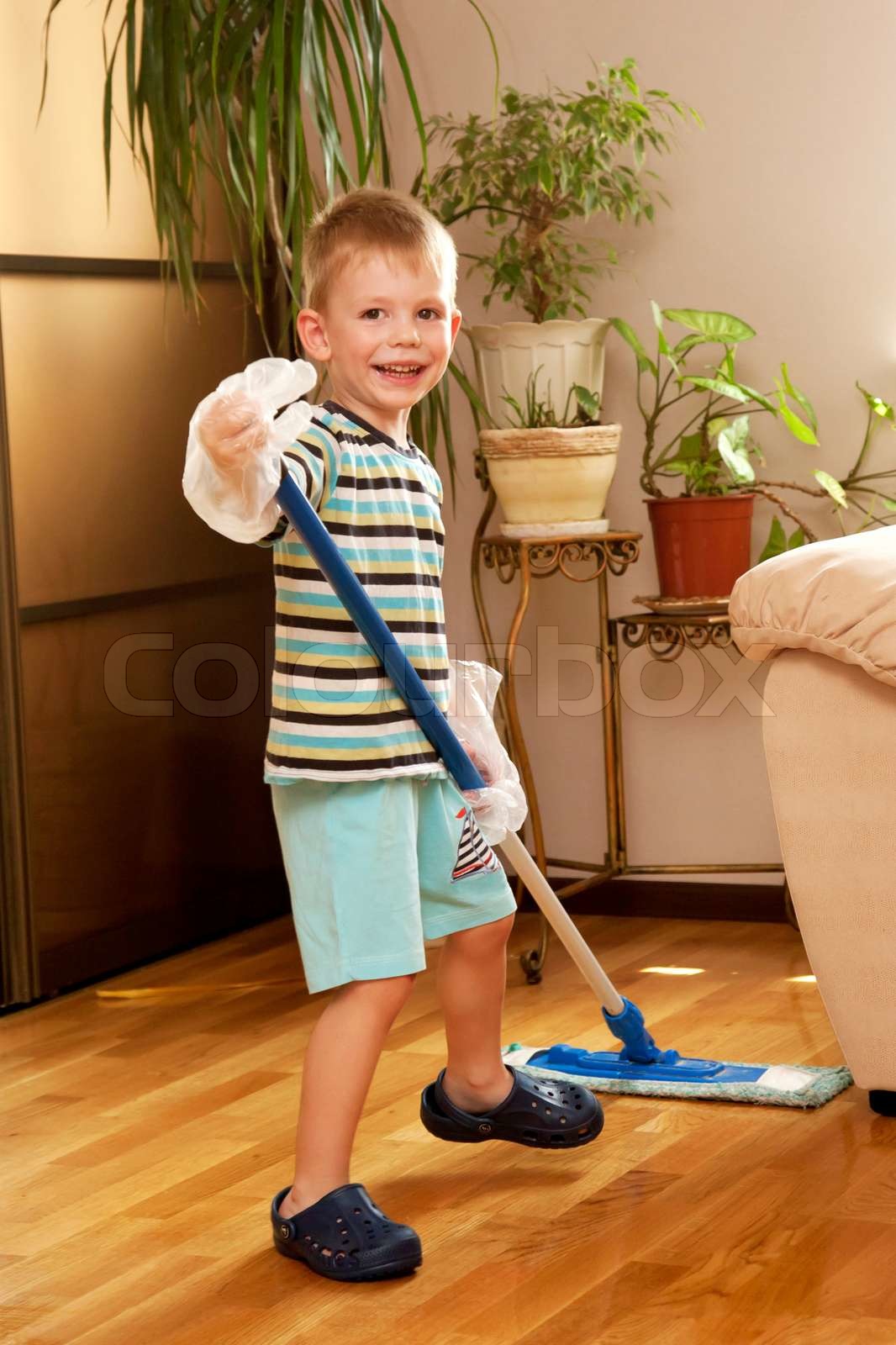 Little boy cleaning the room | Stock image | Colourbox