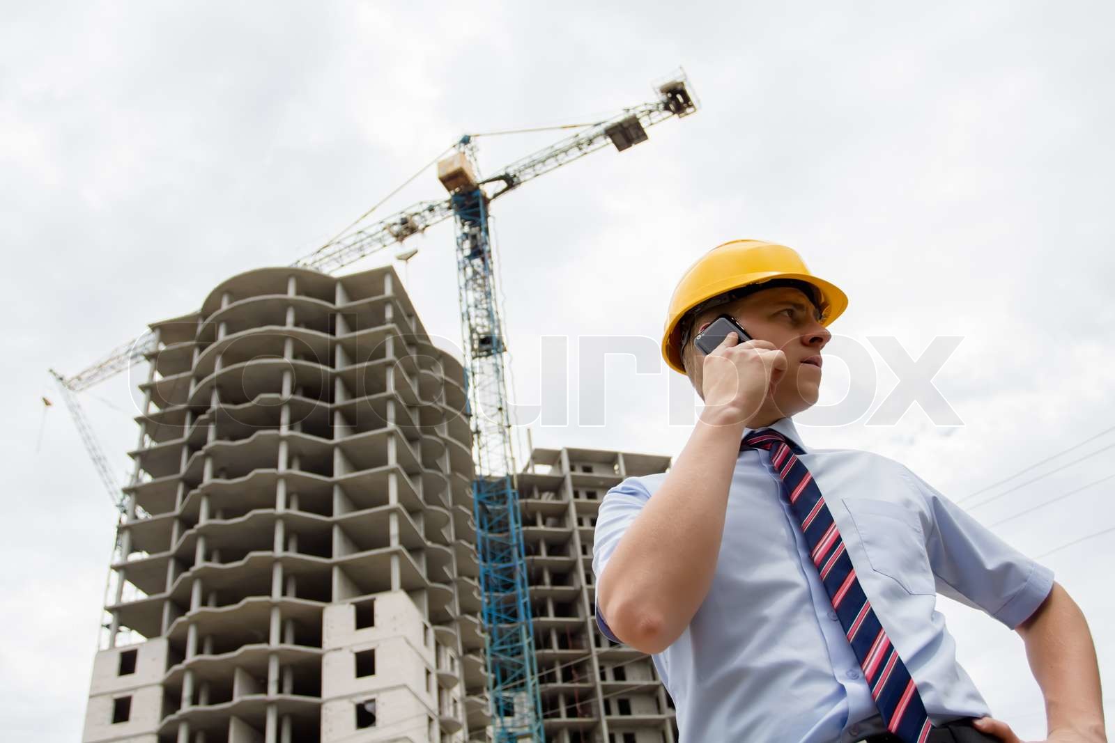 man in a hard hat talking on the phone | Stock image | Colourbox