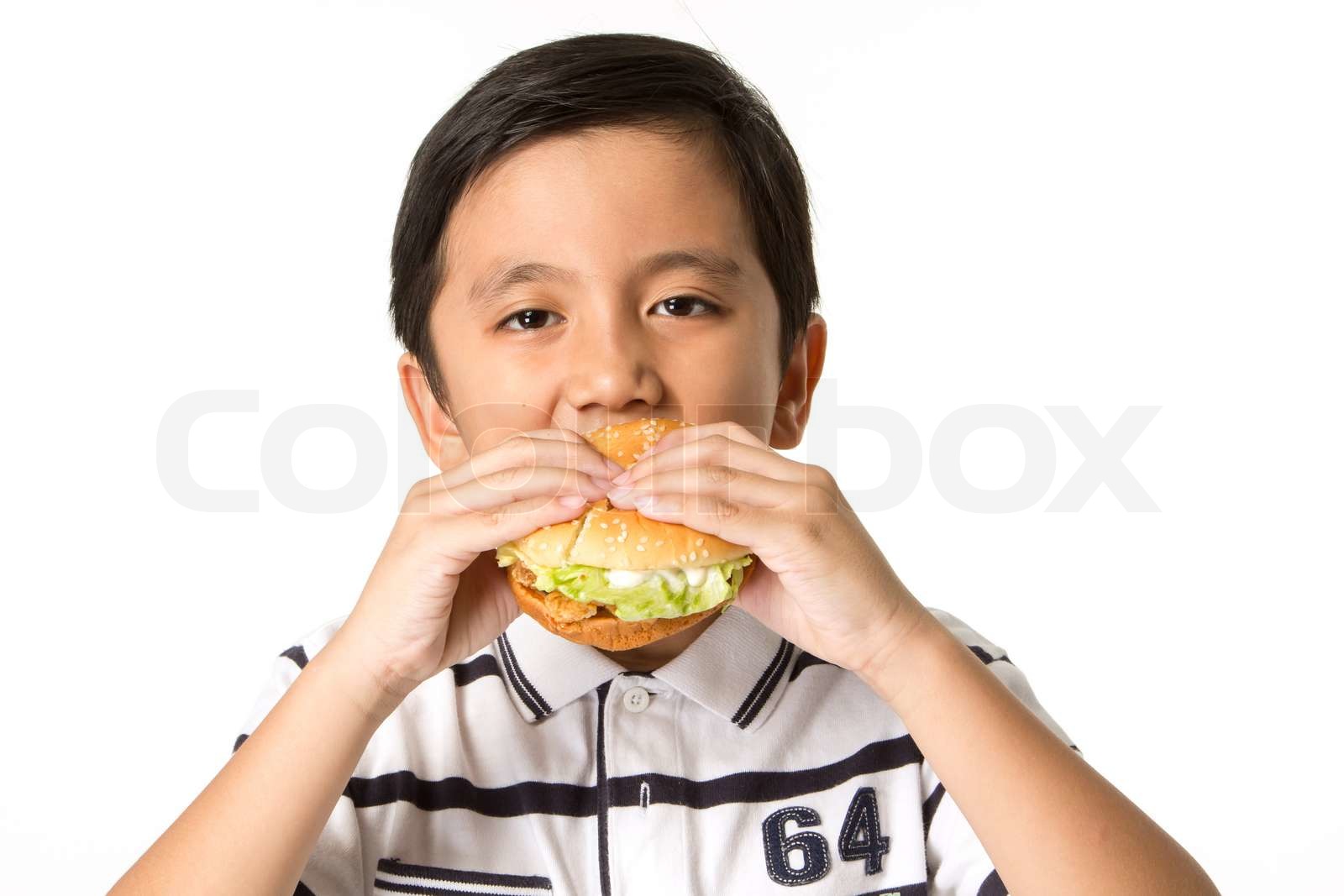 boy eating a burger | Stock image | Colourbox