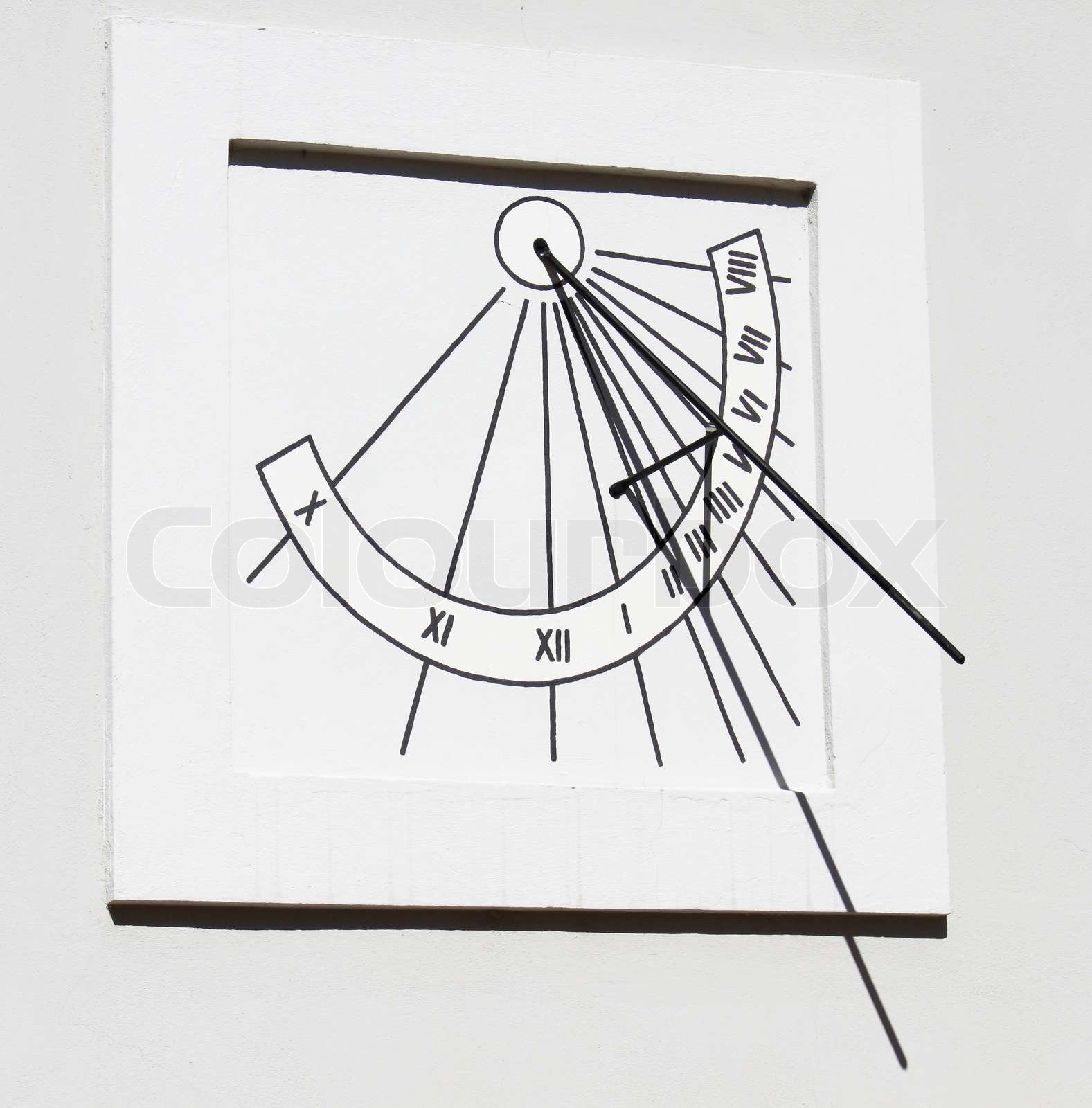 Ancient solar clock is located on the wall | Stock image | Colourbox