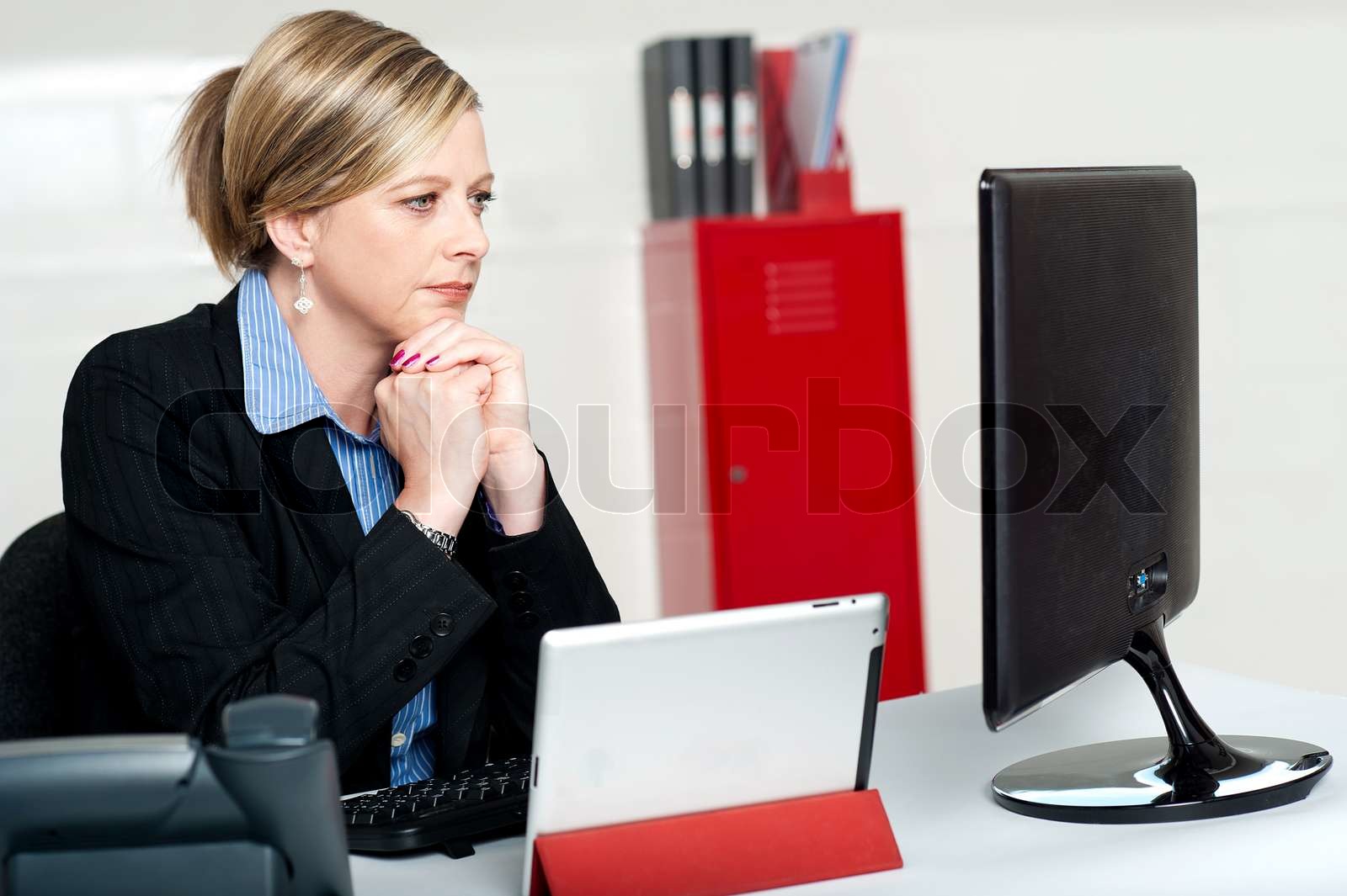 Corporate lady looking into computer screen | Stock image | Colourbox