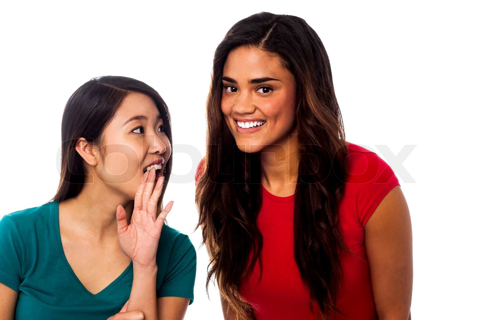 Two pretty young girls gossiping | Stock image | Colourbox