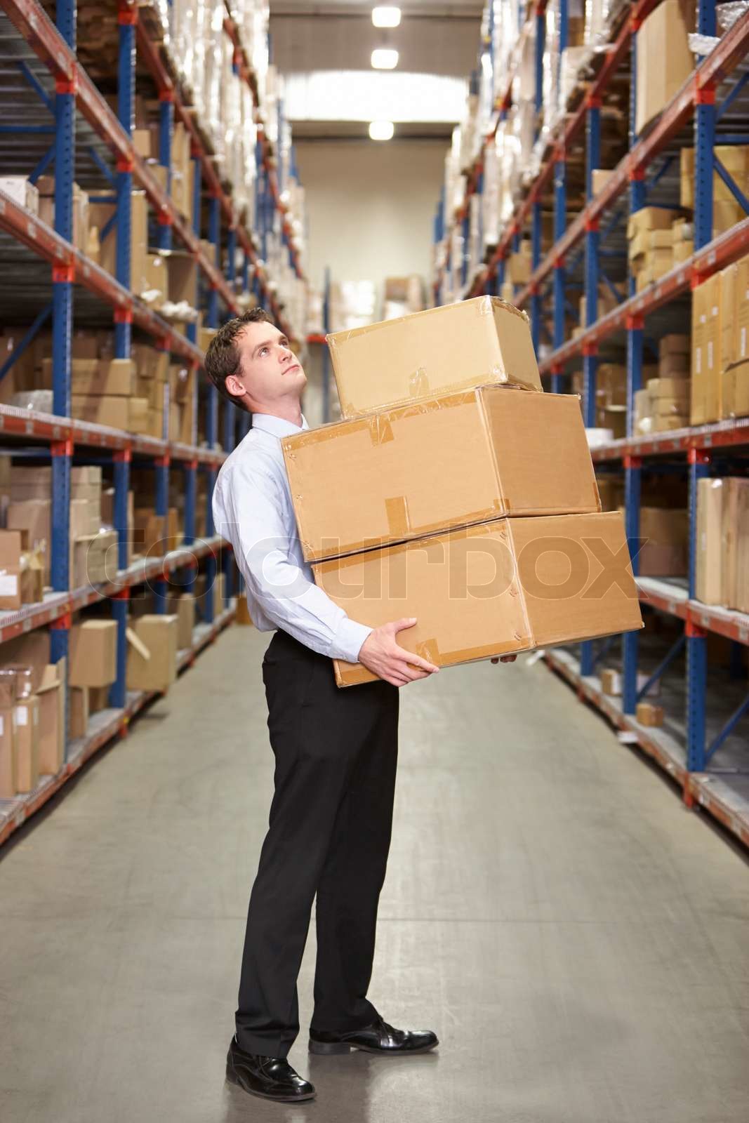 Man Carrying Boxes In Warehouse | Stock image | Colourbox