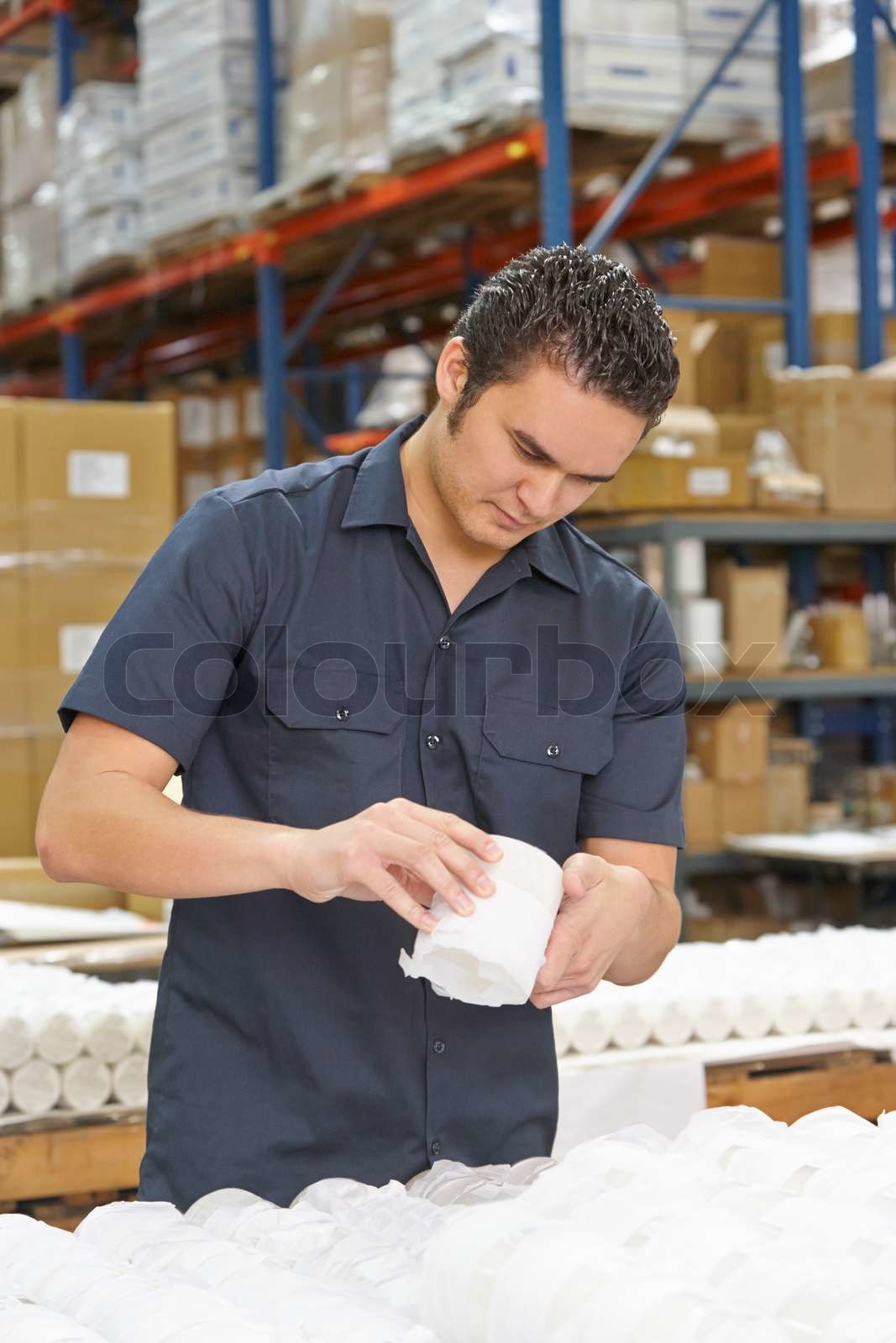 Factory Worker Checking Goods On Production Line | Stock image | Colourbox
