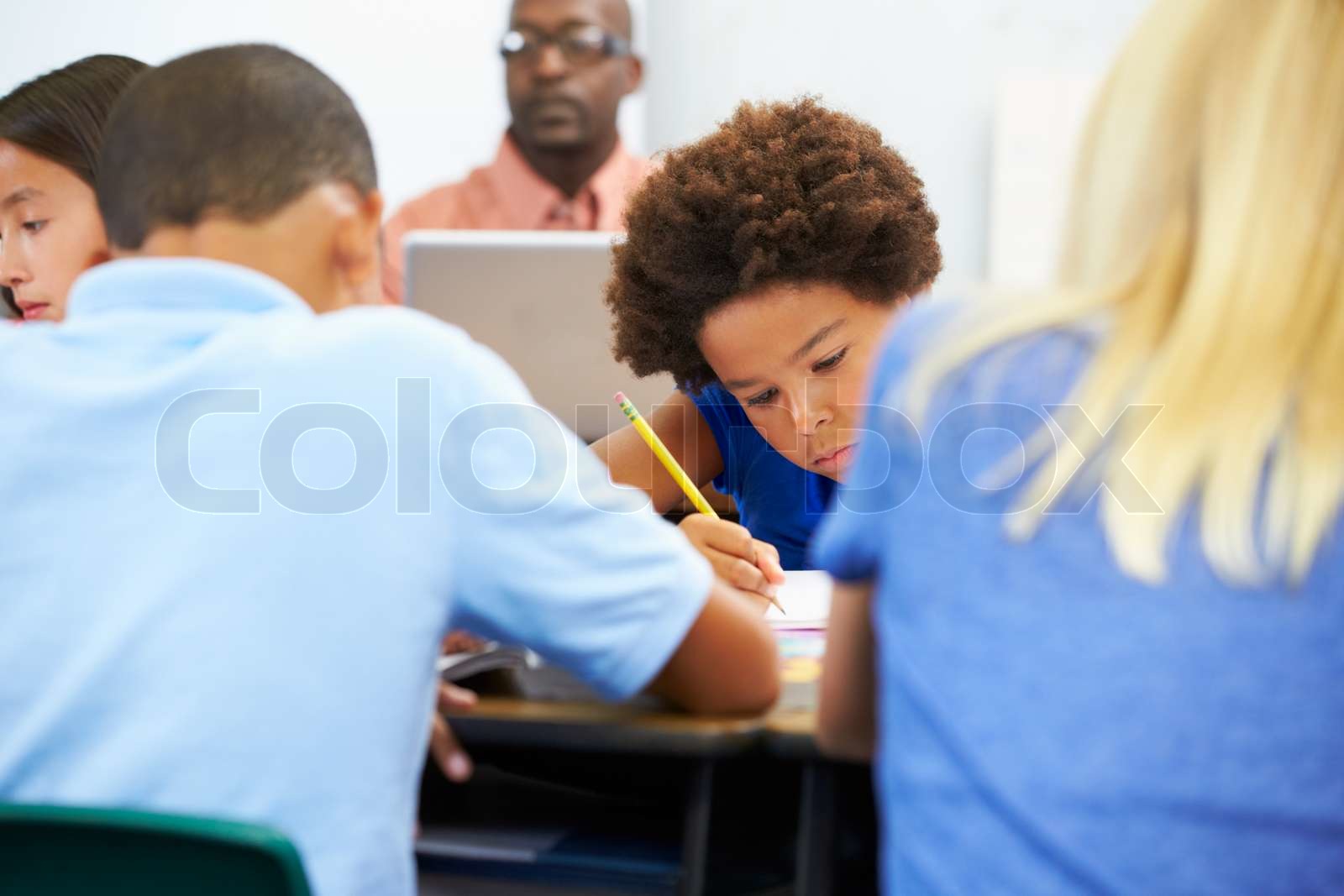 Pupils Studying At Desks In Classroom | Stock image | Colourbox