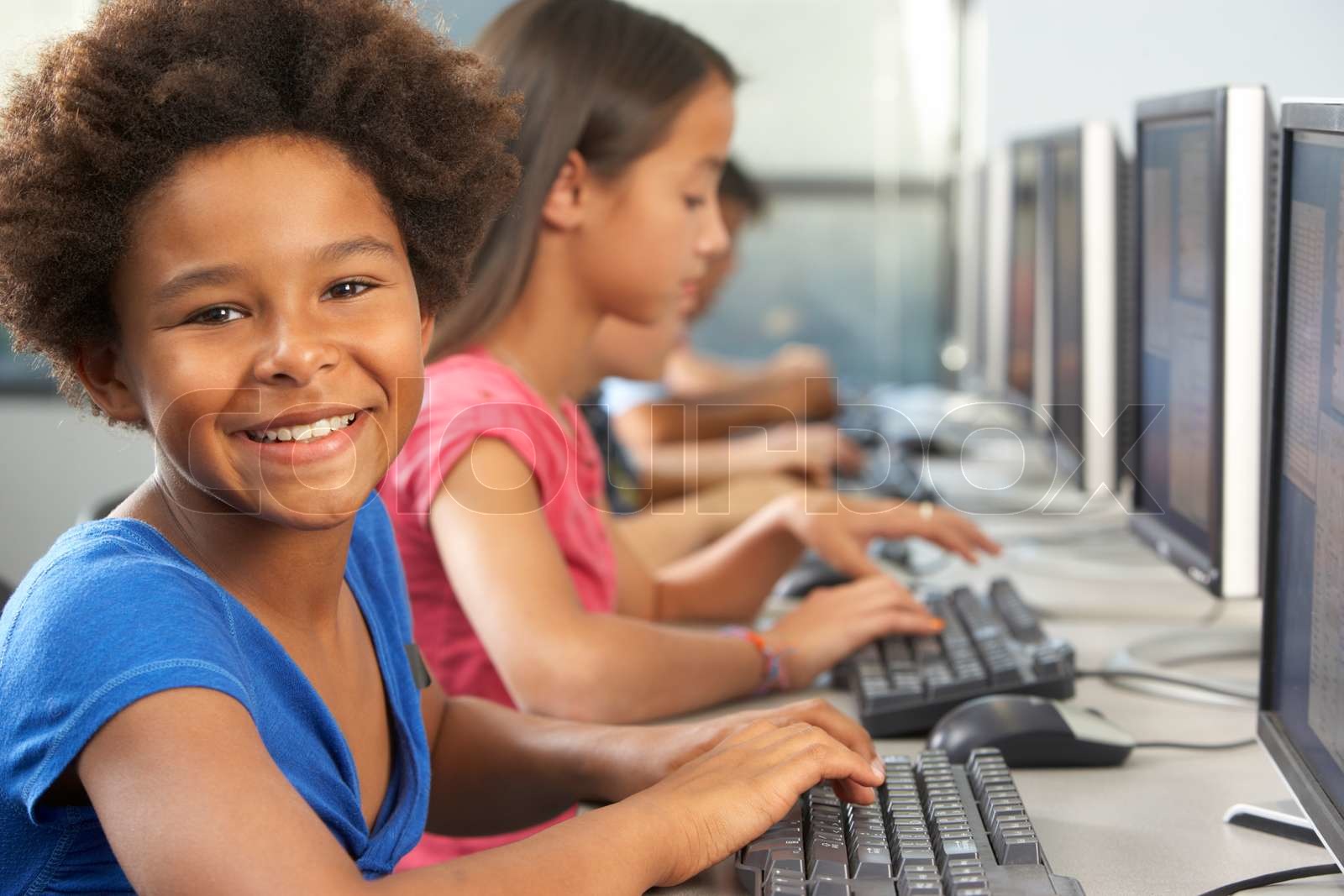 Elementary Students Working At Computers In Classroom | Stock image ...