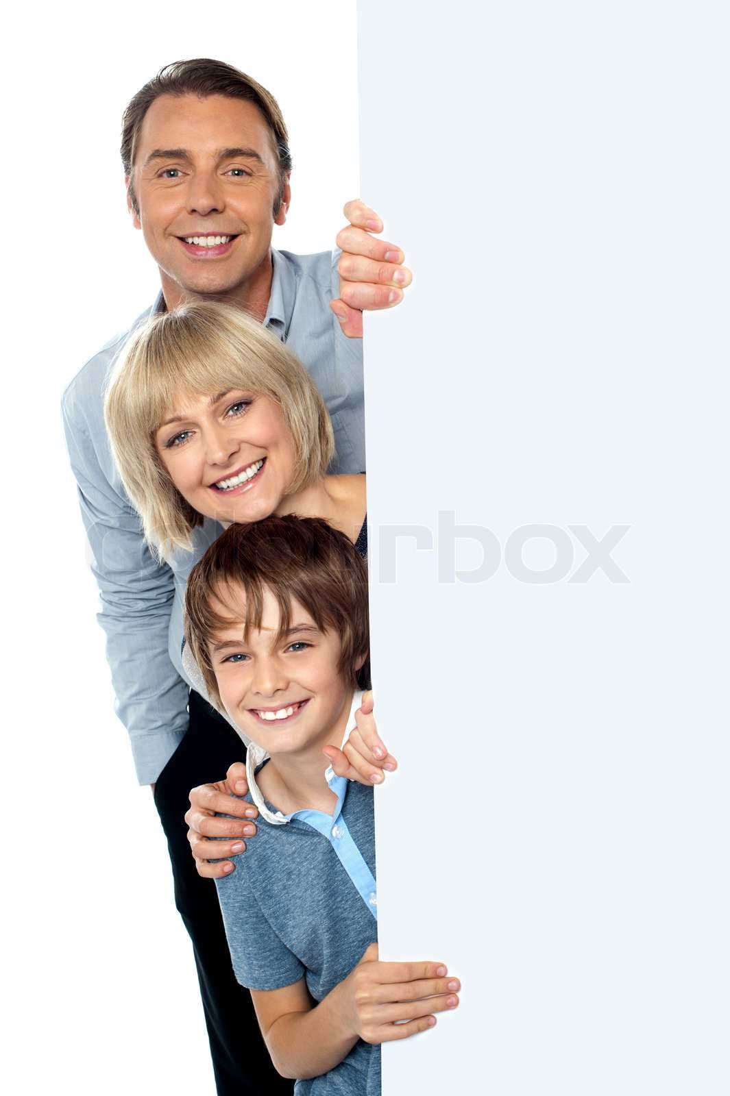 Family of three behind blank whiteboard | Stock image | Colourbox
