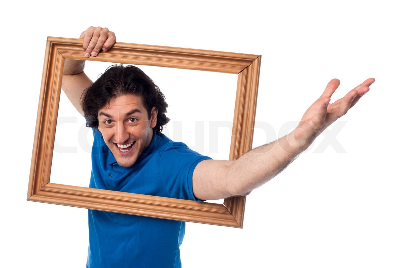 Excited man holding picture frame | Stock image | Colourbox
