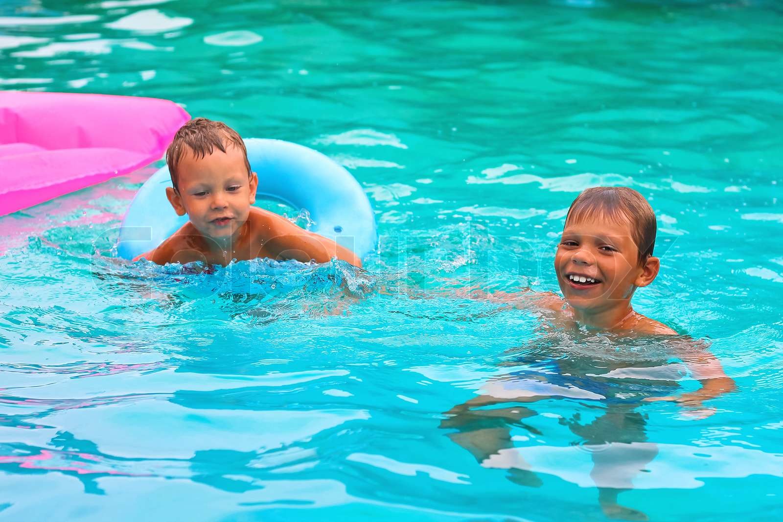 Two brothers are swimming in the pool | Stock image | Colourbox