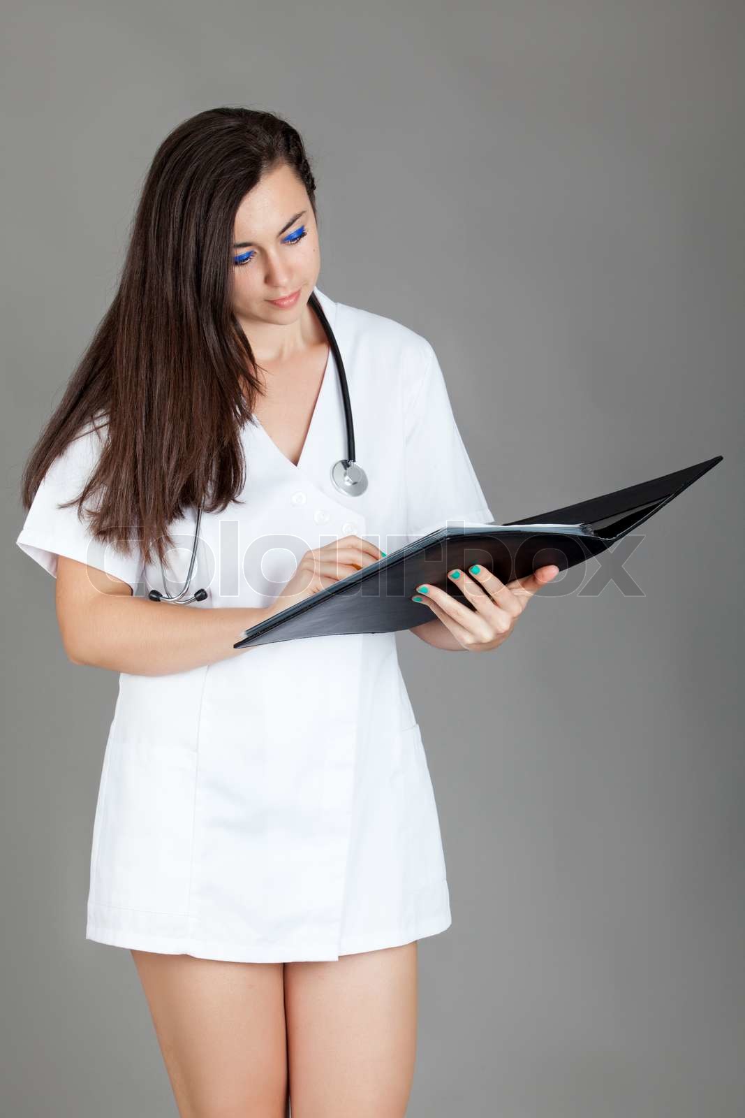 medical doctor woman with stethoscope A female doctor with a folder ...