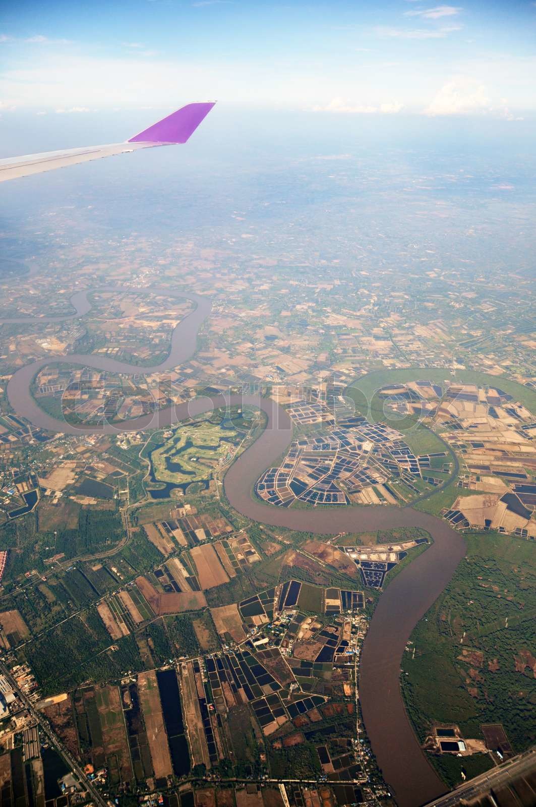 Aerial view of the river flows through residential area | Stock image ...