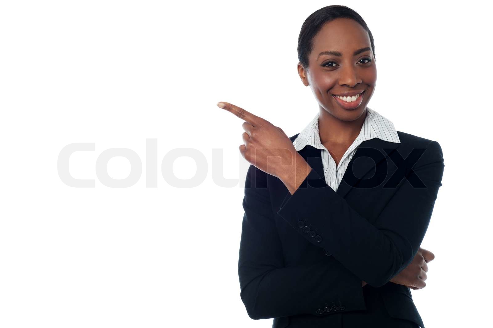 Lady pointing towards copy space area | Stock image | Colourbox