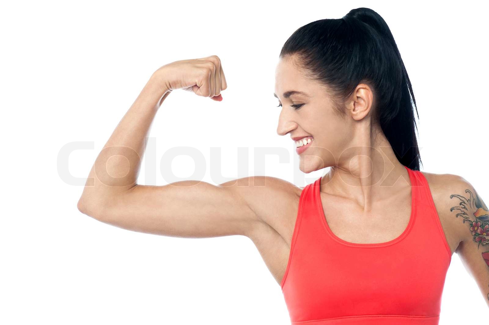 Junge Frau fit ihre Muskeln biegt | Stock Bild | Colourbox