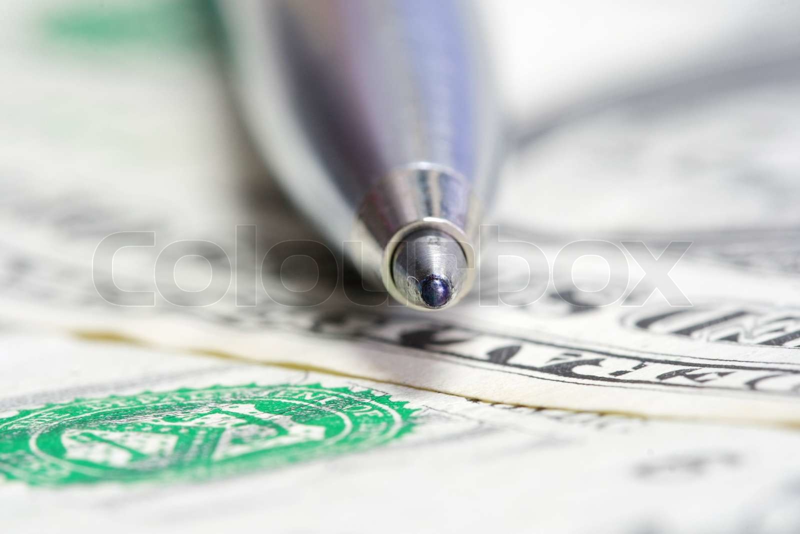 ballpoint metal pen on US dollar bill | Stock image | Colourbox