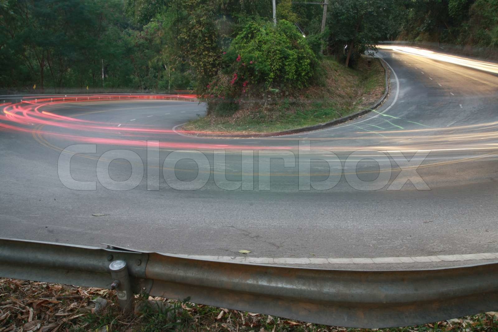 sharp curve road with car light line | Stock image | Colourbox