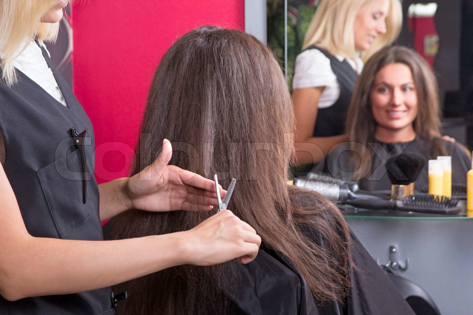 schöne junge Friseur geben einen neuen Haarschnitt zu weiblichen Kunden ...