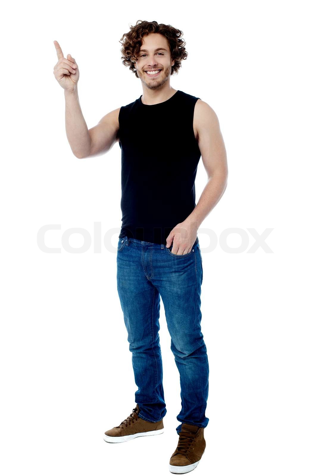 Young smart guy pointing upwards | Stock image | Colourbox