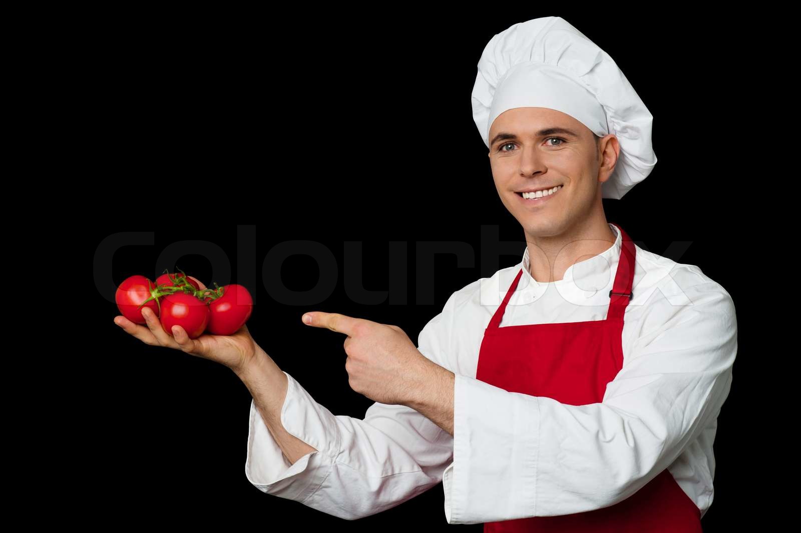 Young chef holding fresh tomatoes | Stock image | Colourbox