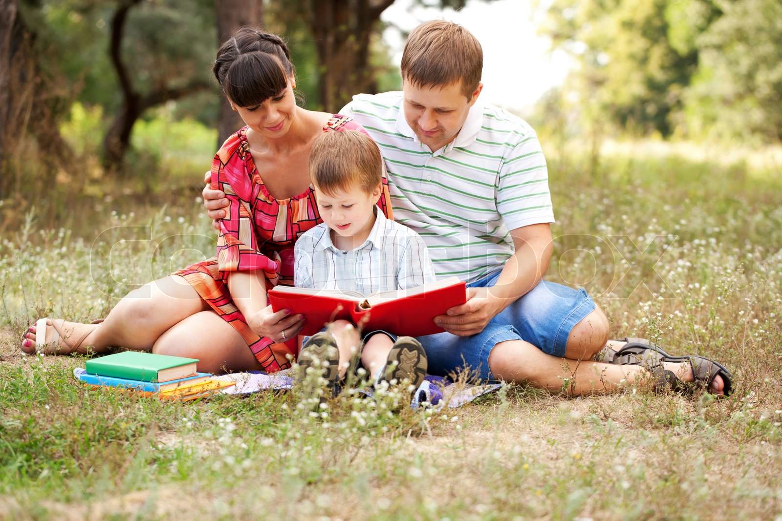 Family reading together Summer holiday | Stock image | Colourbox