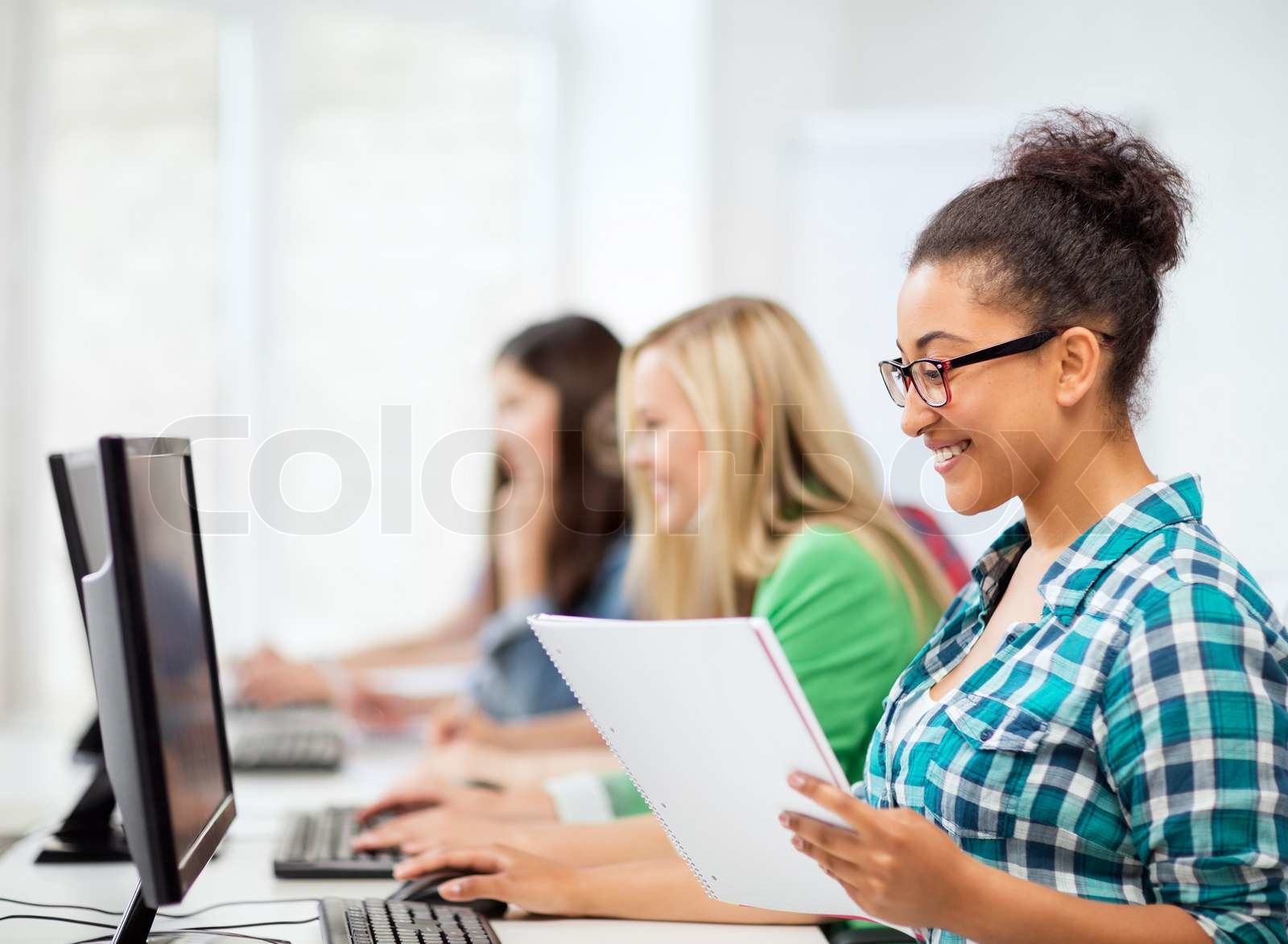 african student with computer studying at school | Stock image | Colourbox