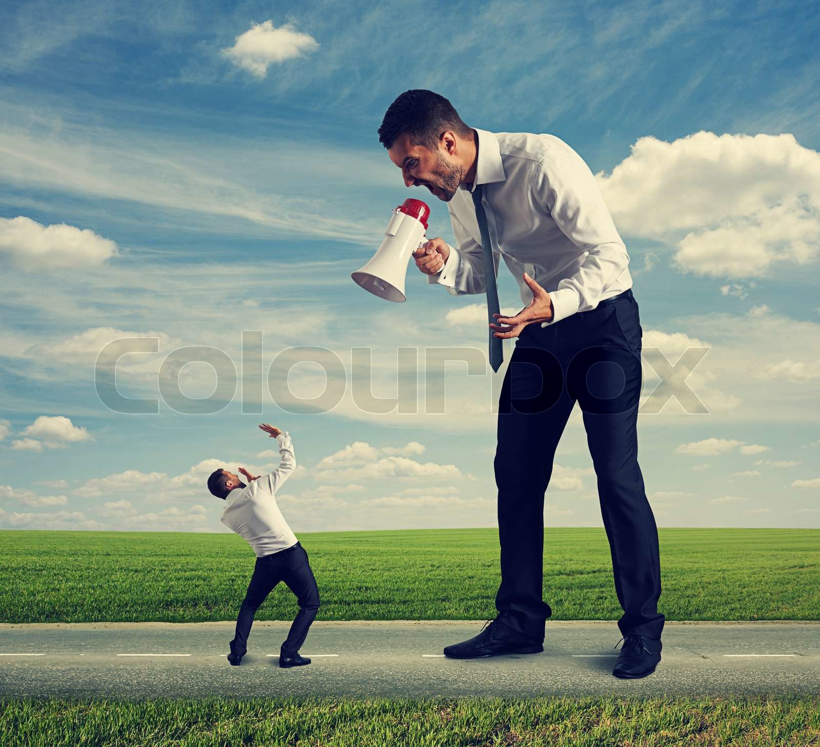 man screaming at the small man | Stock image | Colourbox
