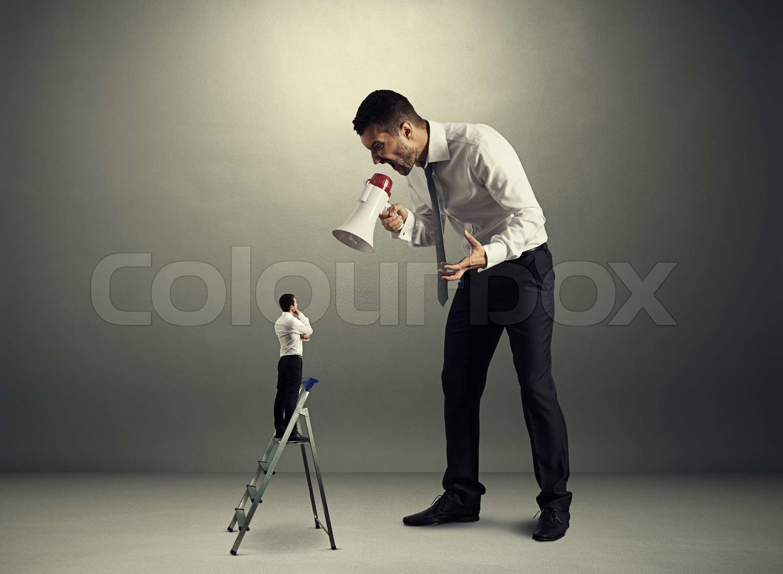 small man looking at big businessman | Stock image | Colourbox