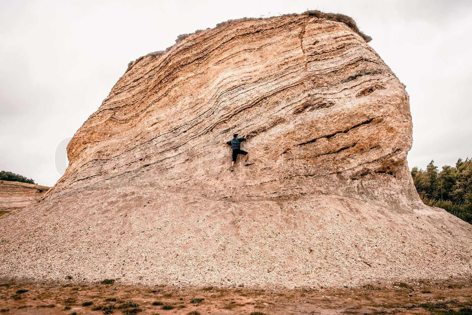 Man climbing a big rock | Stock image | Colourbox