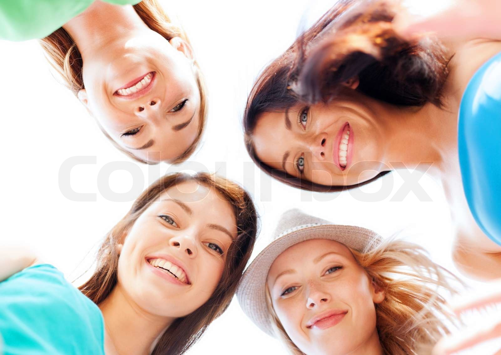faces of girls looking down and smiling | Stock image | Colourbox