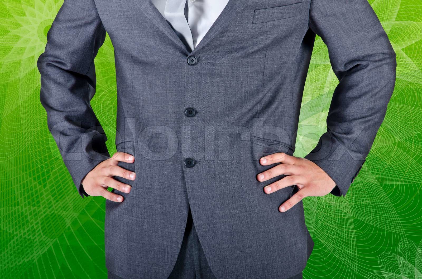 Businessman in suit, hands on hips | Stock image | Colourbox