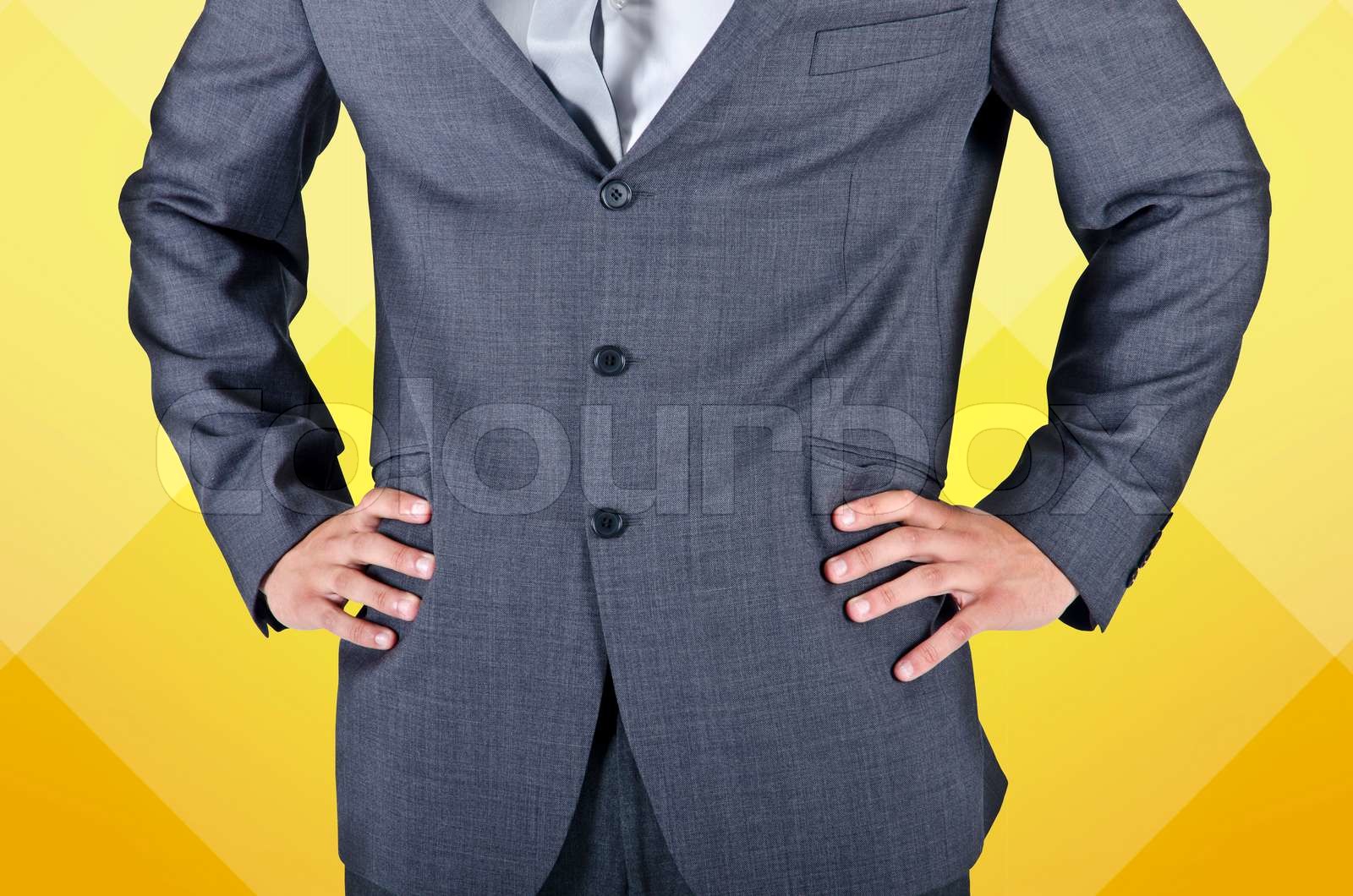 Businessman in suit, hands on hips | Stock image | Colourbox